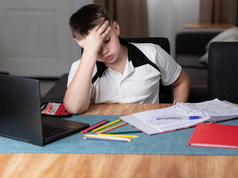 Schoolboy Looking Frustrated and Tired while Doing Homework Stock Photo ...