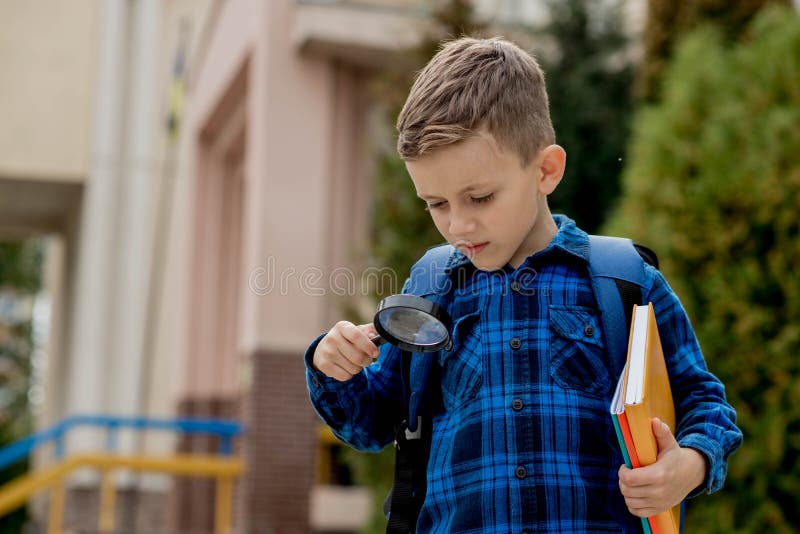 Schoolboy Looking through a Magnifying Glass, with a Surprised ...