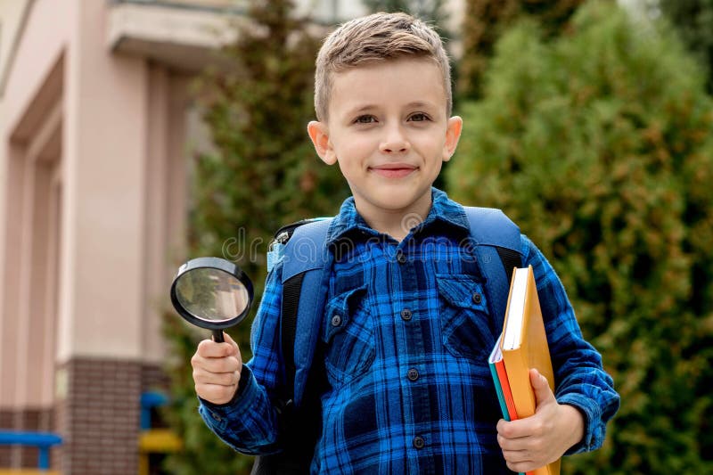 Schoolboy Looking through a Magnifying Glass, with a Surprised ...