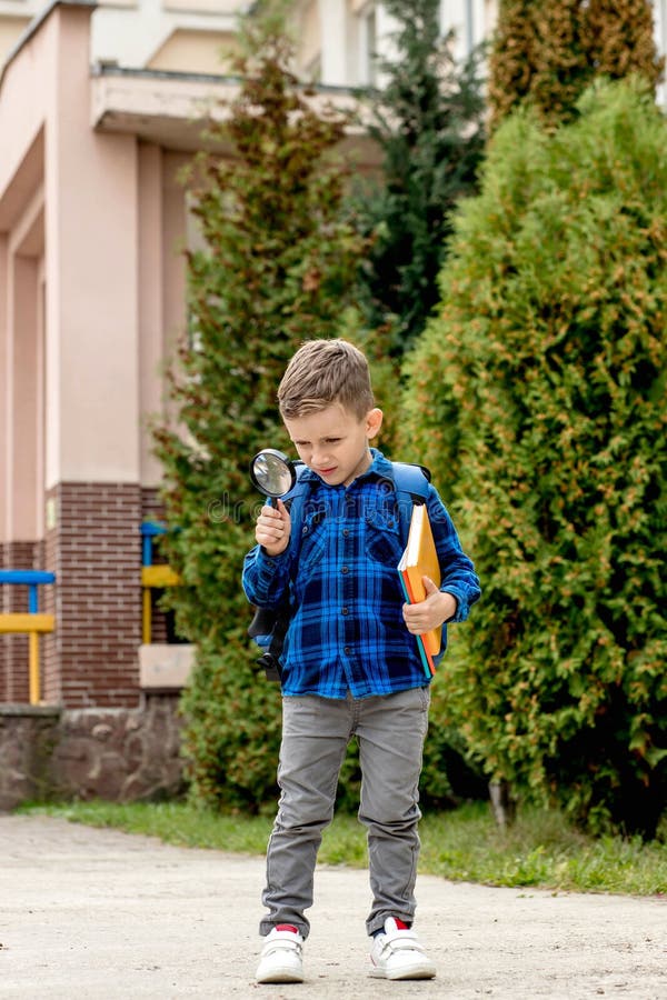 Schoolboy Looking through a Magnifying Glass, with a Surprised ...
