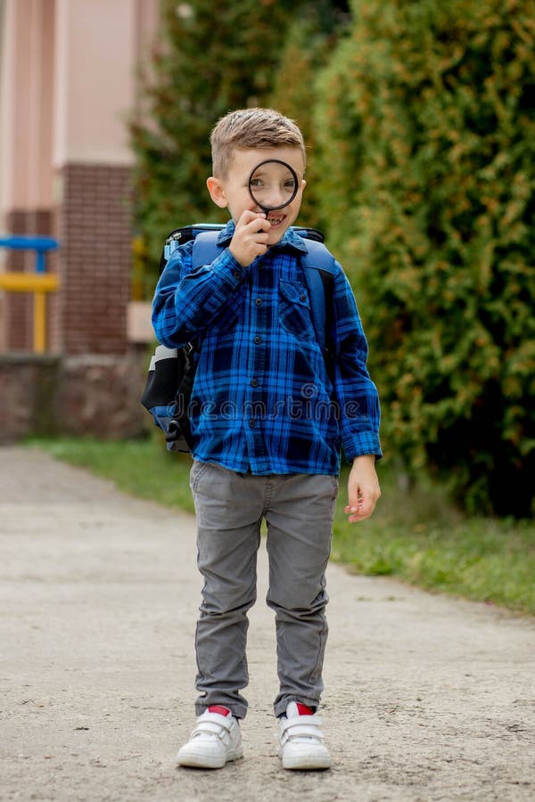 Schoolboy Looking through a Magnifying Glass, with a Surprised ...