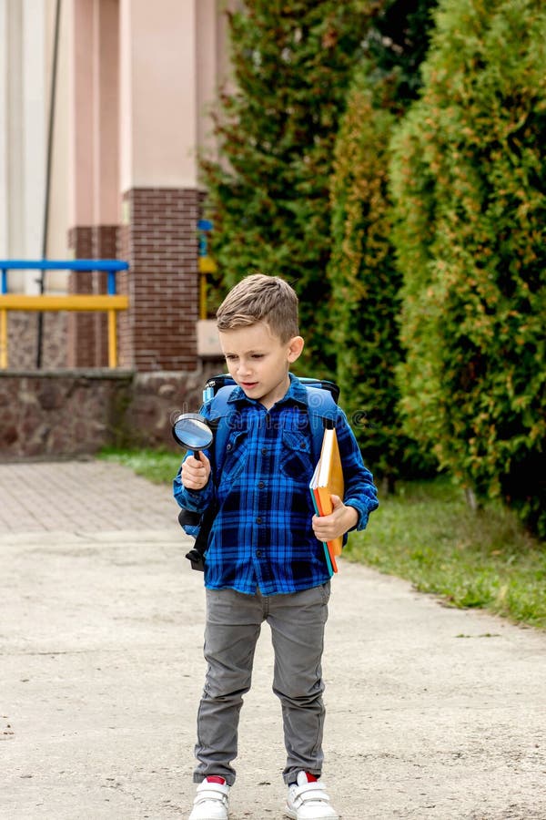 Schoolboy Looking through a Magnifying Glass, with a Surprised ...