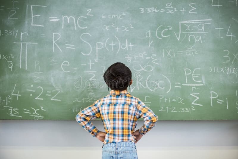 Schoolboy Looking Mathematics on Chalkboard in Classroom Stock Photo ...