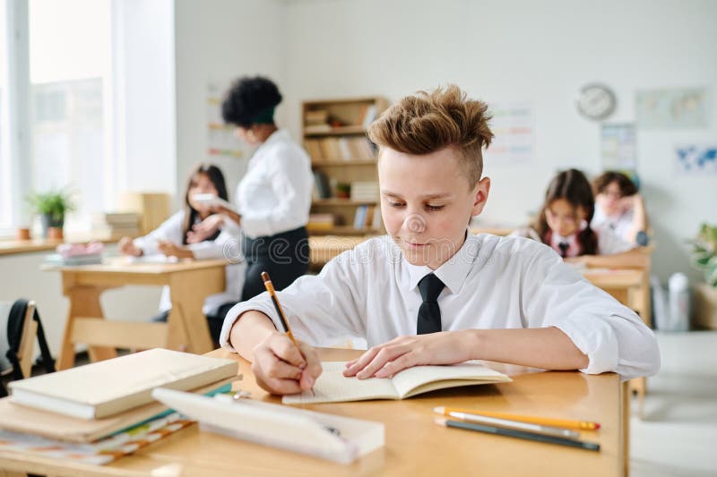 Schoolboy Making Notes during Lesson Stock Photo - Image of lesson ...