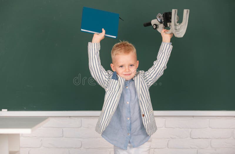 Schoolboy with Microscope and Book. School Boy Studying Math on Lesson ...