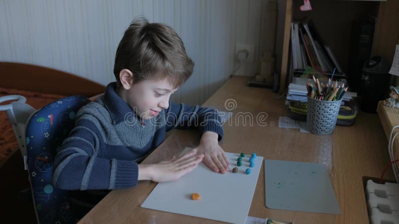 Schoolboy Models Geometric Shapes from Matches and Plasticine. Boy Does ...