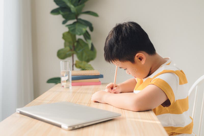 Schoolboy Playing Online Game on Laptop at Home Sitting Table ... Schoolboy Playing Online Game on Laptop at Home Sitting Table ...