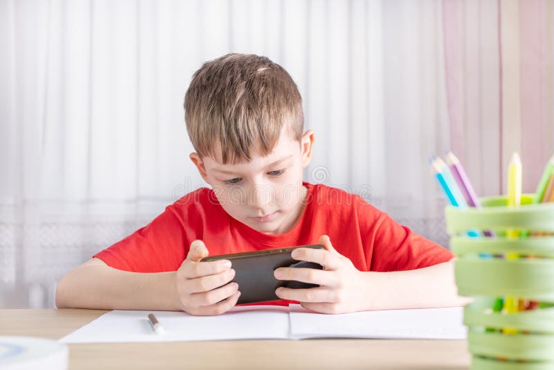 Schoolboy Playing on Smartphone and Does Not Do Homework Stock Image ...