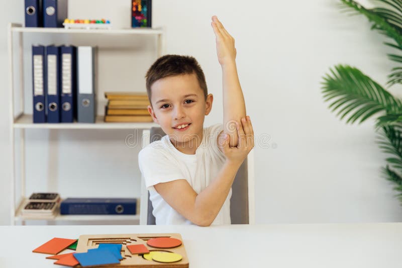 A Schoolboy Raised His Hand Up To Answer in a Classroom Stock Image ...