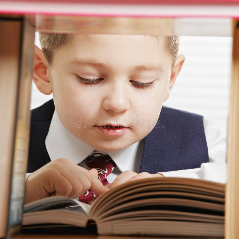 Schoolboy reading book stock photo. Image of closeup - 26604170