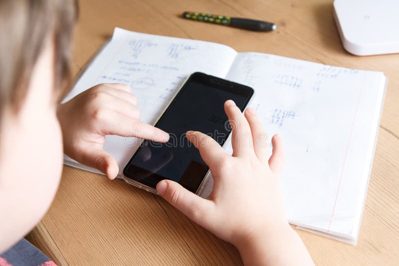 Schoolboy with Smartphone Doing Homework at Home Stock Image - Image of ...