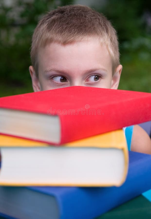 Schoolboy and Stack of Books Stock Photo - Image of caucasian, child ...
