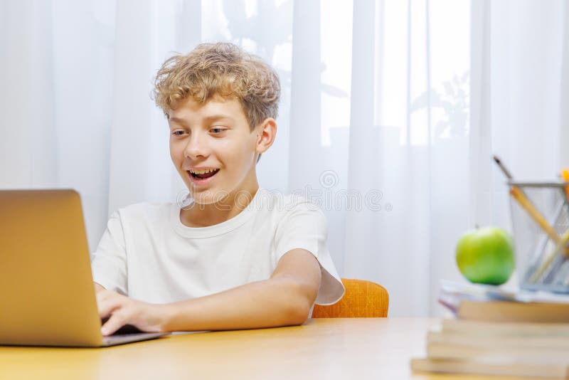 Schoolboy Studying at Home with a Laptop, Smiling with a Joyful Expression Stock Photo - Image ...