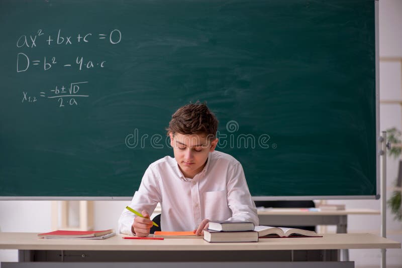 Schoolboy Studying Math in Front of Blackboard Stock Photo - Image of ...