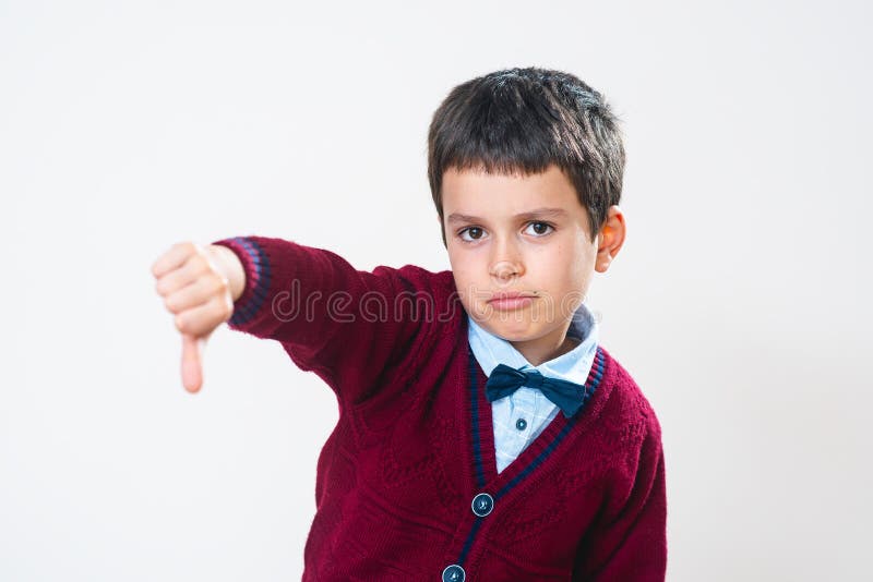Schoolboy in a Sweater Shows a Thumb Down with a Negative Facial ...