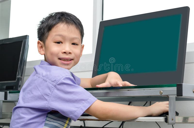 Schoolboy using computer stock image. Image of male, desktop - 55326071