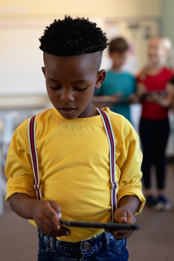 Schoolboy Using a Tablet Computer in an Elementary School Classroom ...