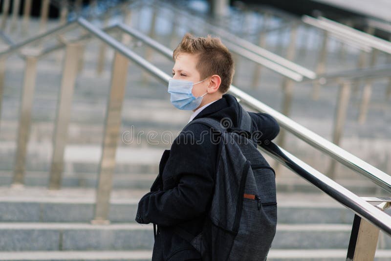Schoolboy Walks Out of School Wearing Protective Mask in a City Stock ... Schoolboy Walks Out of School Wearing Protective Mask in a City Stock ...