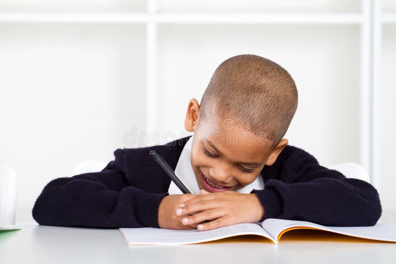 Schoolboy writing homework stock photo. Image of grader - 20483994
