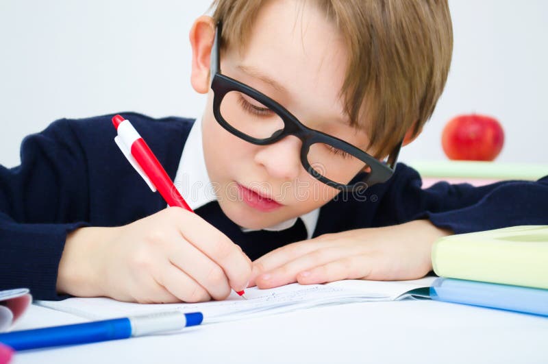 Schoolboy Writing Homework from School in Workbook Stock Image - Image ...