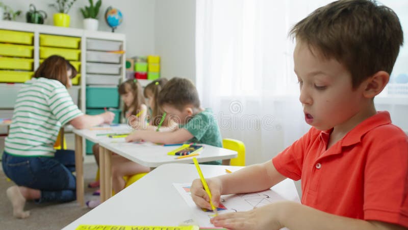 Schoolchildren at Desks with Pens Perform the Teacher S Tasks in the ...