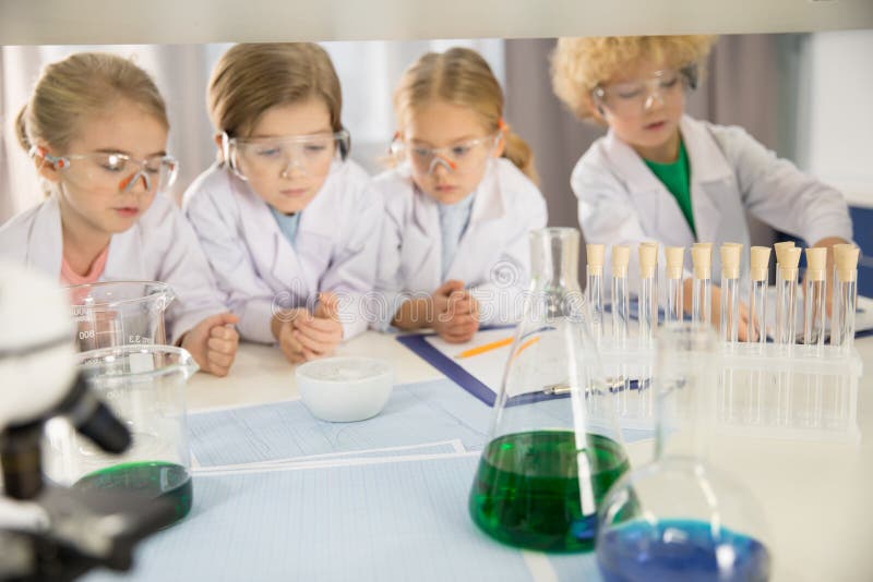 Schoolboy in Lab Coat Looking at Sample in Test Tube Stock Photo ...