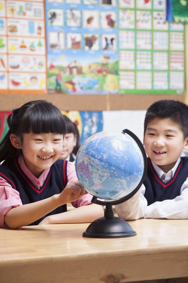 Schoolchildren Looking at a Globe in the Classroom Stock Image - Image ... Schoolchildren Looking at a Globe in the Classroom Stock Image - Image ...