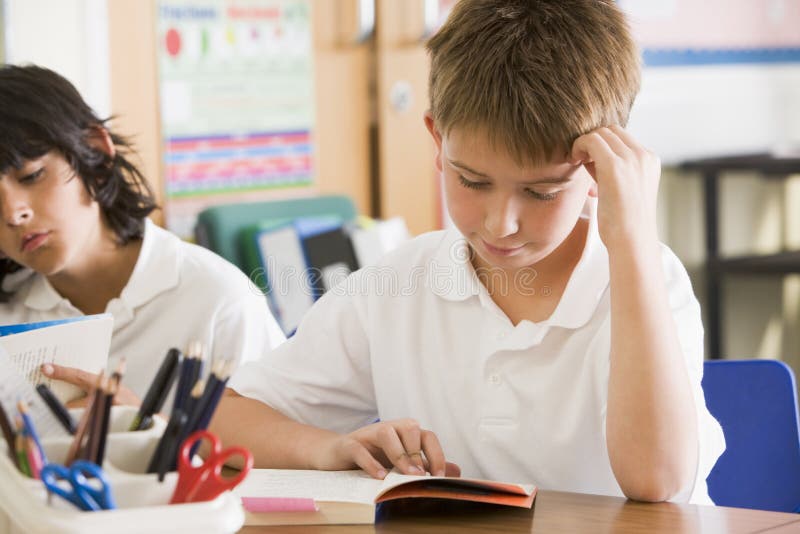 Schoolchildren Reading Books in Class Stock Photo - Image of studying ...