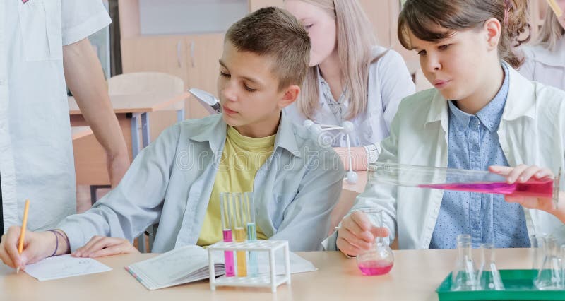 Schoolchildren Doing Experiment in Science Class Stock Image - Image of ...