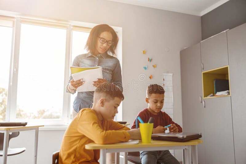 Two Boys Writing during a Lesson and a Test at School Stock Photo ...