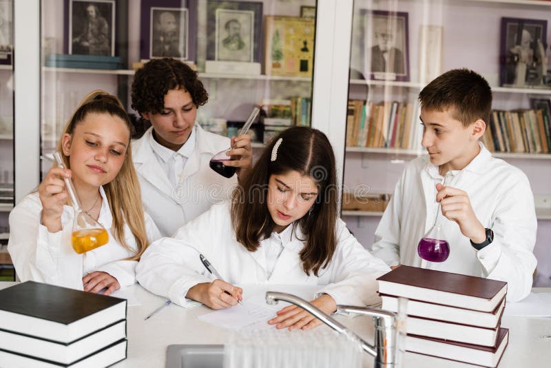 Schoolchildren Studying at Chemistry Lesson in Classrom. Pupils Writing ...