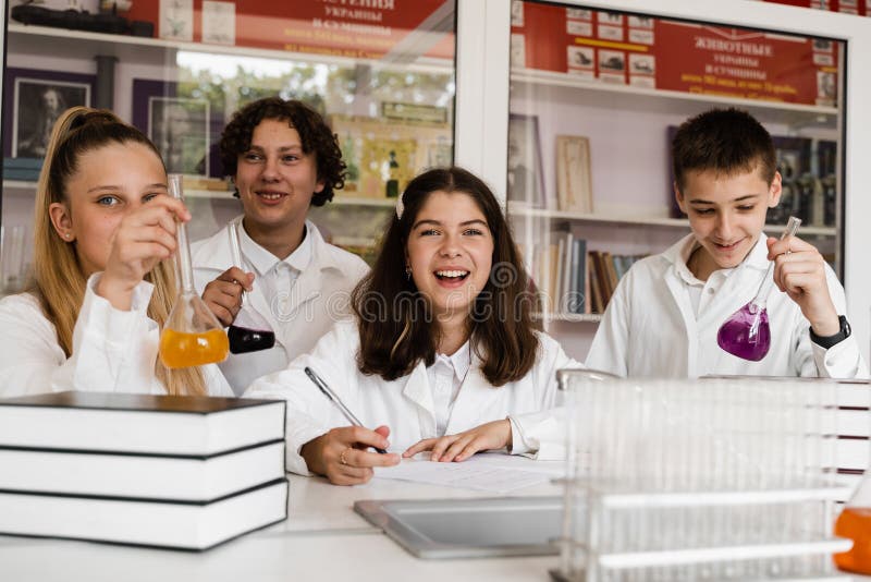 Schoolchildren Studying at Chemistry Lesson in Classrom. Pupils Writing ...
