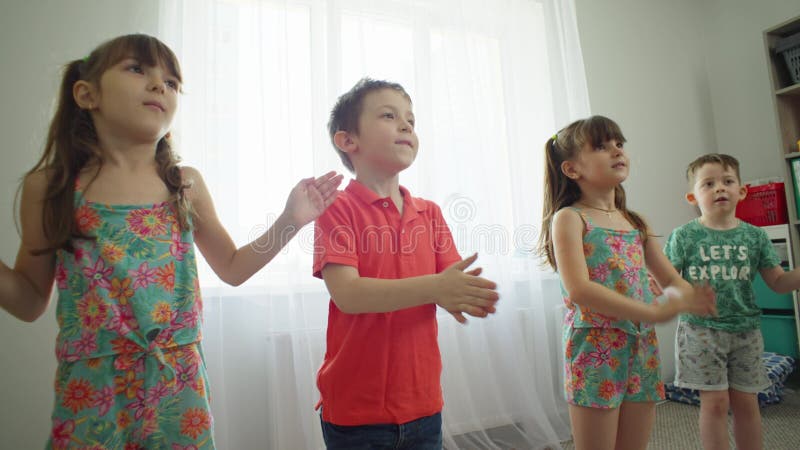 Schoolchildren and the Teacher are Having Fun and Dancing in a Lesson ...