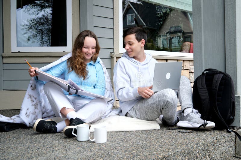 Schoolchildren Teenagers on Doorstep at Home Doing Homework Boy in ... Schoolchildren Teenagers on Doorstep at Home Doing Homework Boy in ...