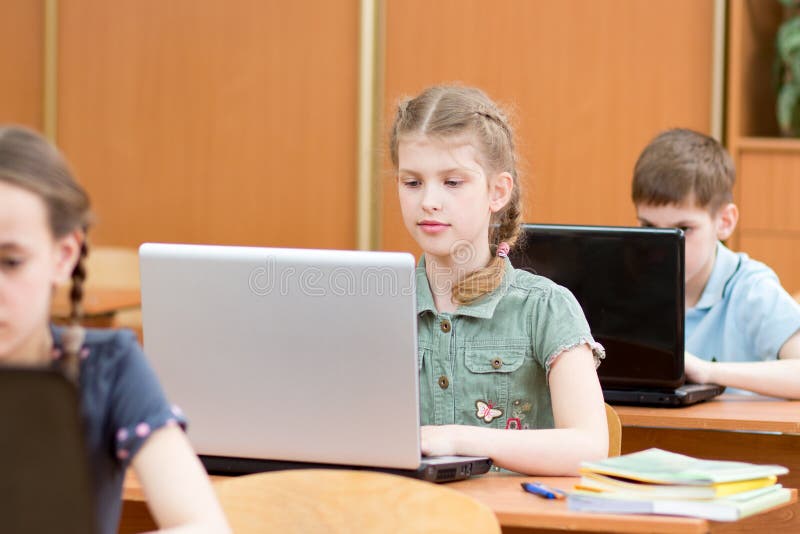 Schoolchildren Using Laptop at Lesson in Classroom Stock Photo - Image ...