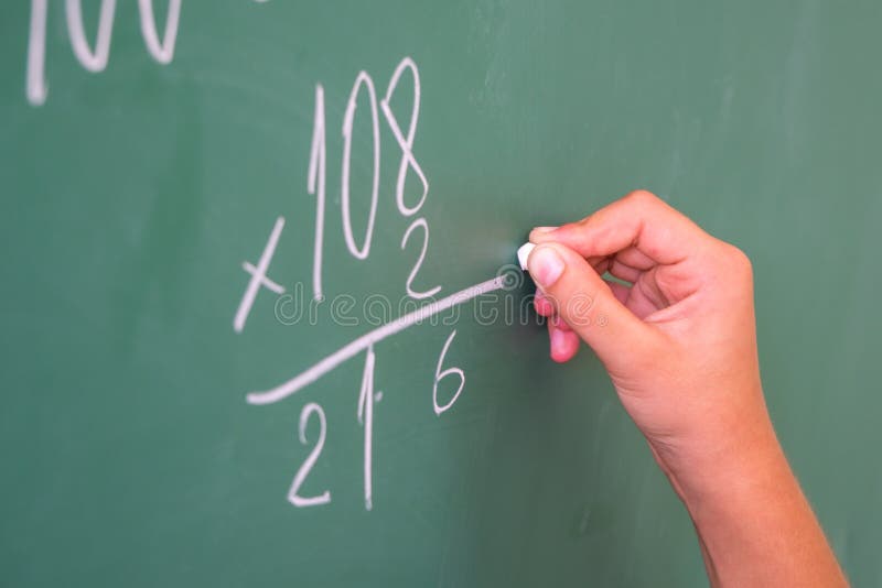 Schoolgirl with Chalk at the Blackboard Solves a Math Problem Stock ...