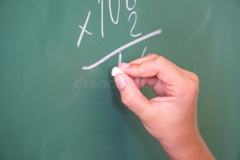 Schoolgirl with Chalk at the Blackboard Solves a Math Problem Stock ...