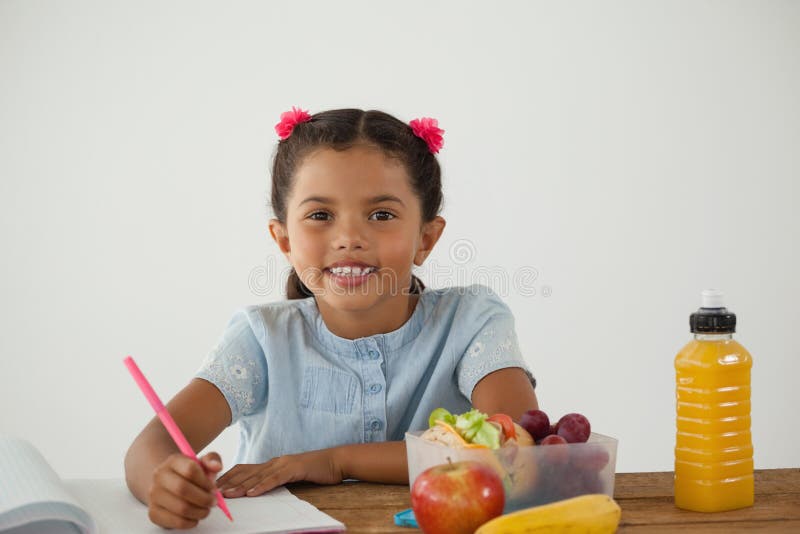Schoolgirl Doing Her Homework Against White Background Stock Photo ...