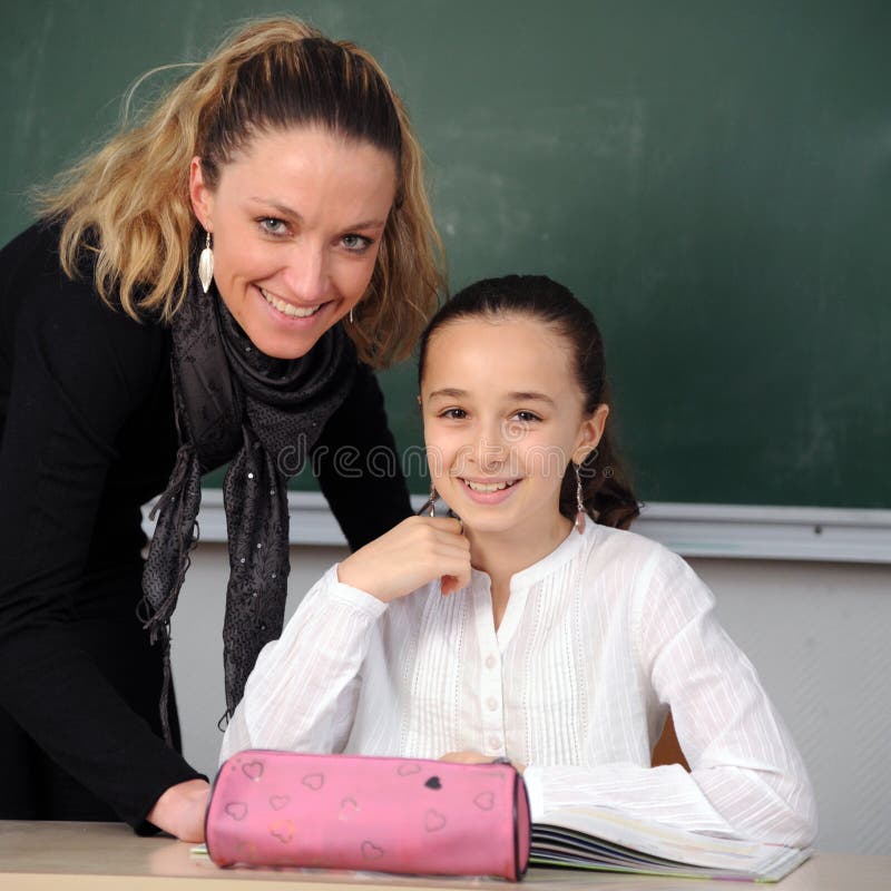 Schoolgirl and her teacher stock photo. Image of classroom - 55947990