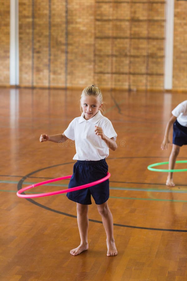 Schoolgirl Playing with Hula Hoop in School Gym Stock Photo - Image of ...