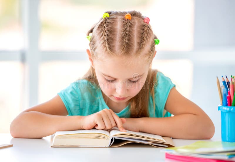 Schoolgirl reading book stock photo. Image of interest - 165277668