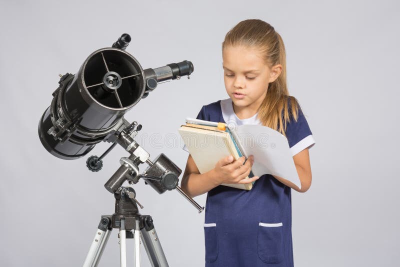 Schoolgirl Astronomer Leafing through Books To Find the Right ...