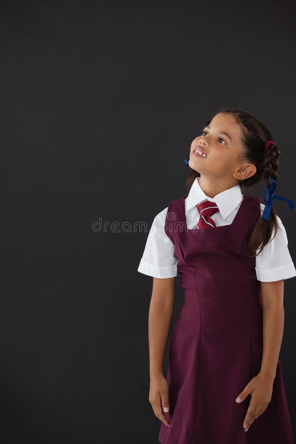 Schoolgirl Standing Against Blackboard in Classroom Stock Photo - Image ...