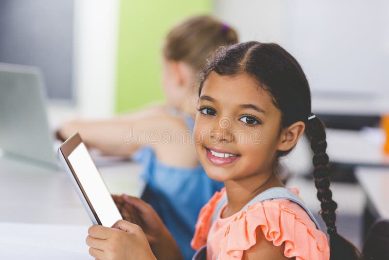 Schoolgirl Using Digital Tablet in Classroom Stock Image - Image of ...