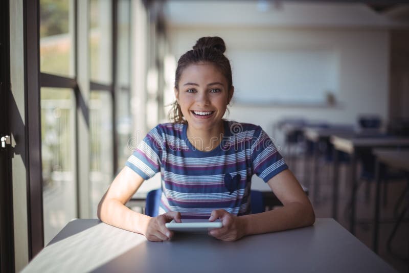 Schoolgirl Using Digital Tablet in Classroom Stock Photo - Image of ...