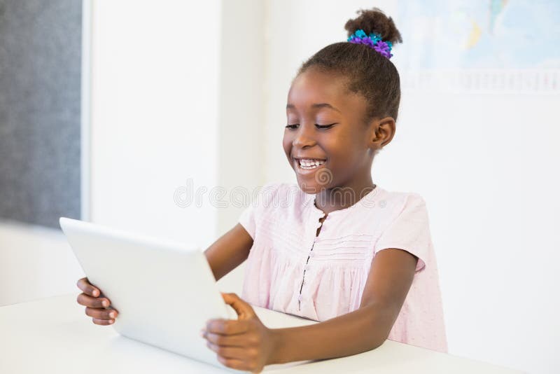 Schoolgirl Using Digital Tablet in Classroom Stock Image - Image of ...