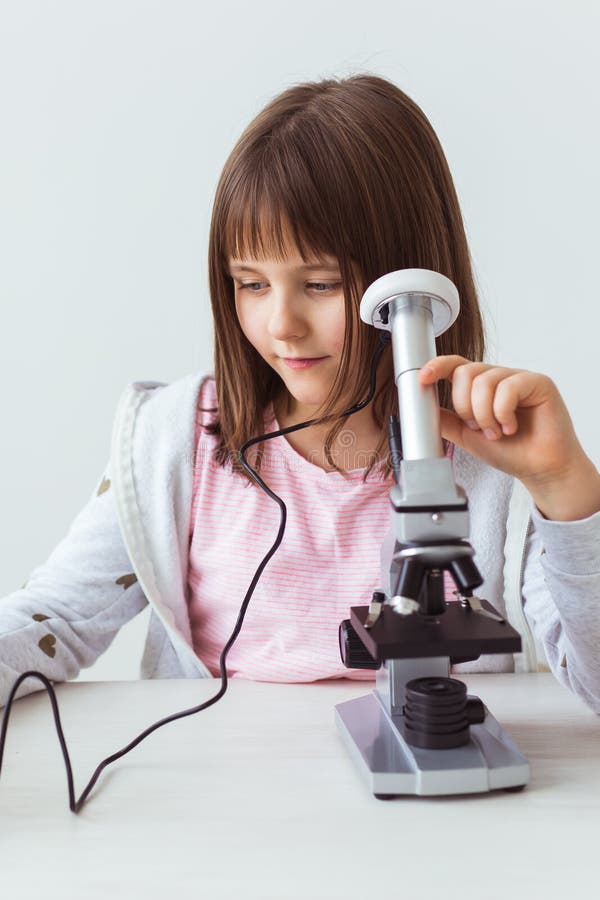 Schoolgirl Using Microscope in Science Class. Technologies, Lessons and ...