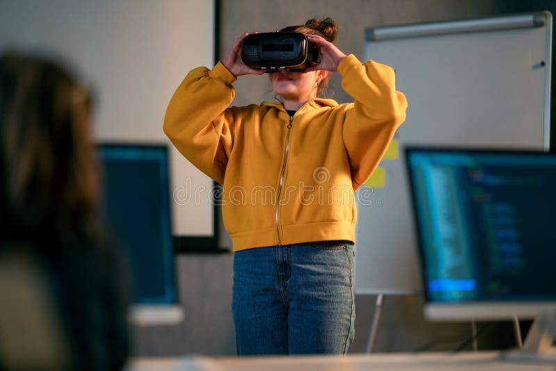 Schoolgirl Wearing Virtual Reality Goggles at School in Computer ...