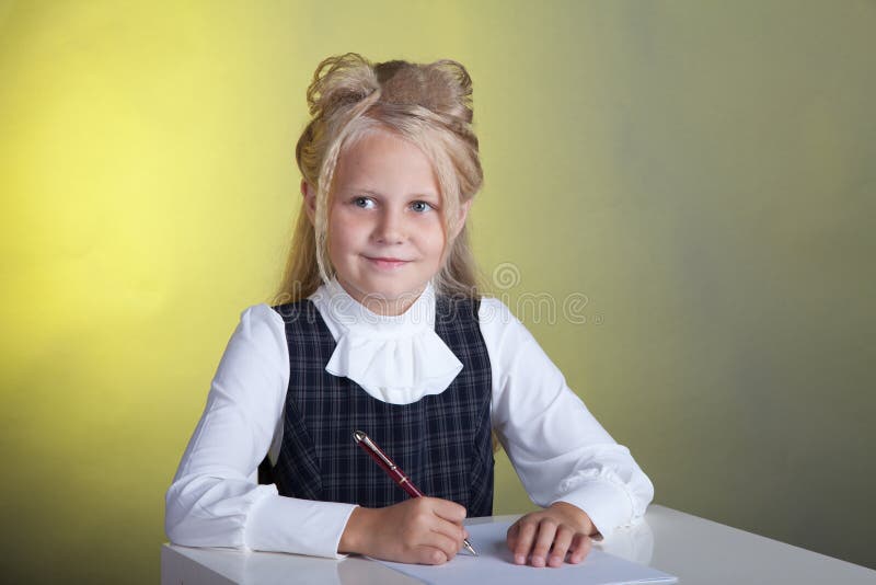 Schoolgirl in School Uniform Writing at the Table. Stock Photo - Image ...