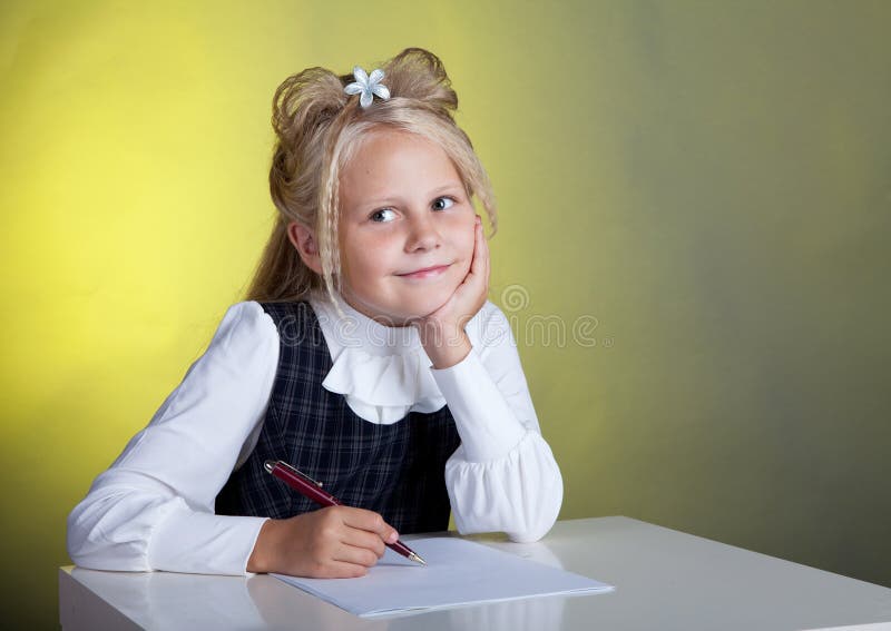 Schoolgirl in School Uniform Writing at the Table. Stock Photo - Image ...